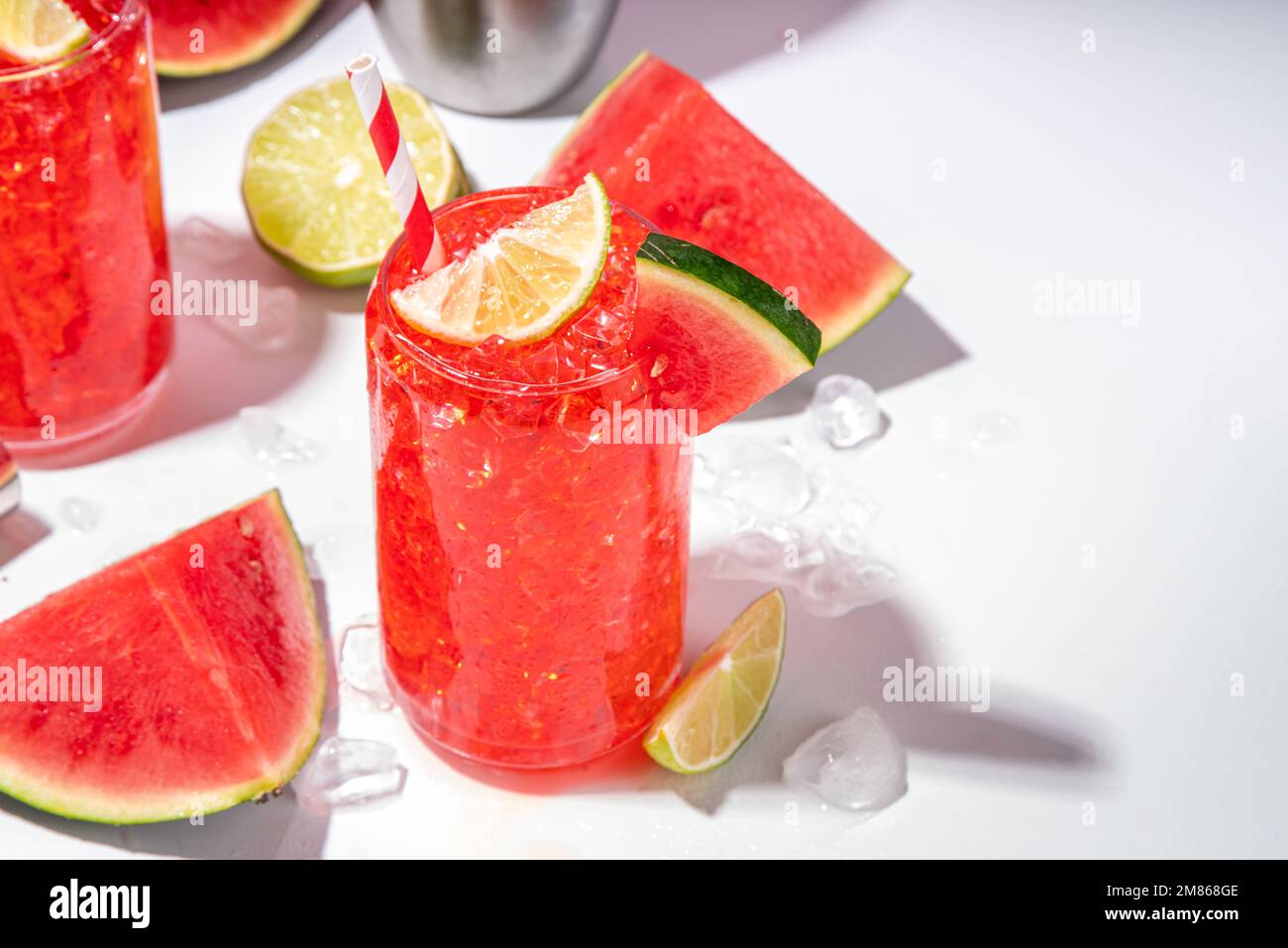 Watermelon lemonade cocktail with lime and sliced watermelon, on trendy ...
