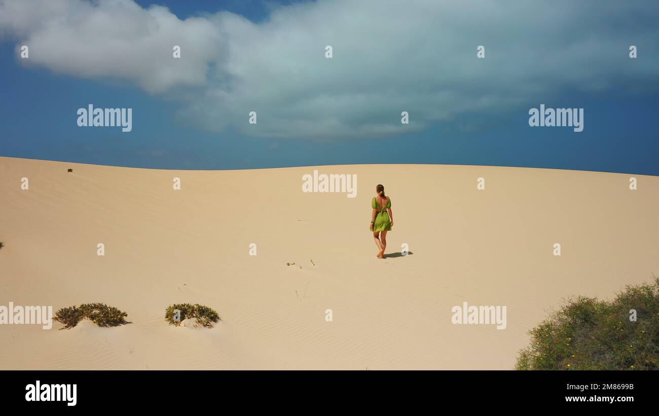 Nature landscape. Golden sand dunes. Travel aerial view of young female ...