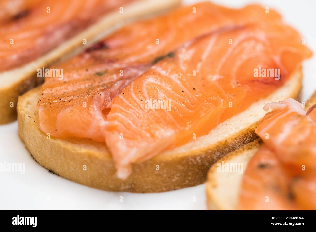 Bread with fresh salted salmon fillet isolated on white background, top ...