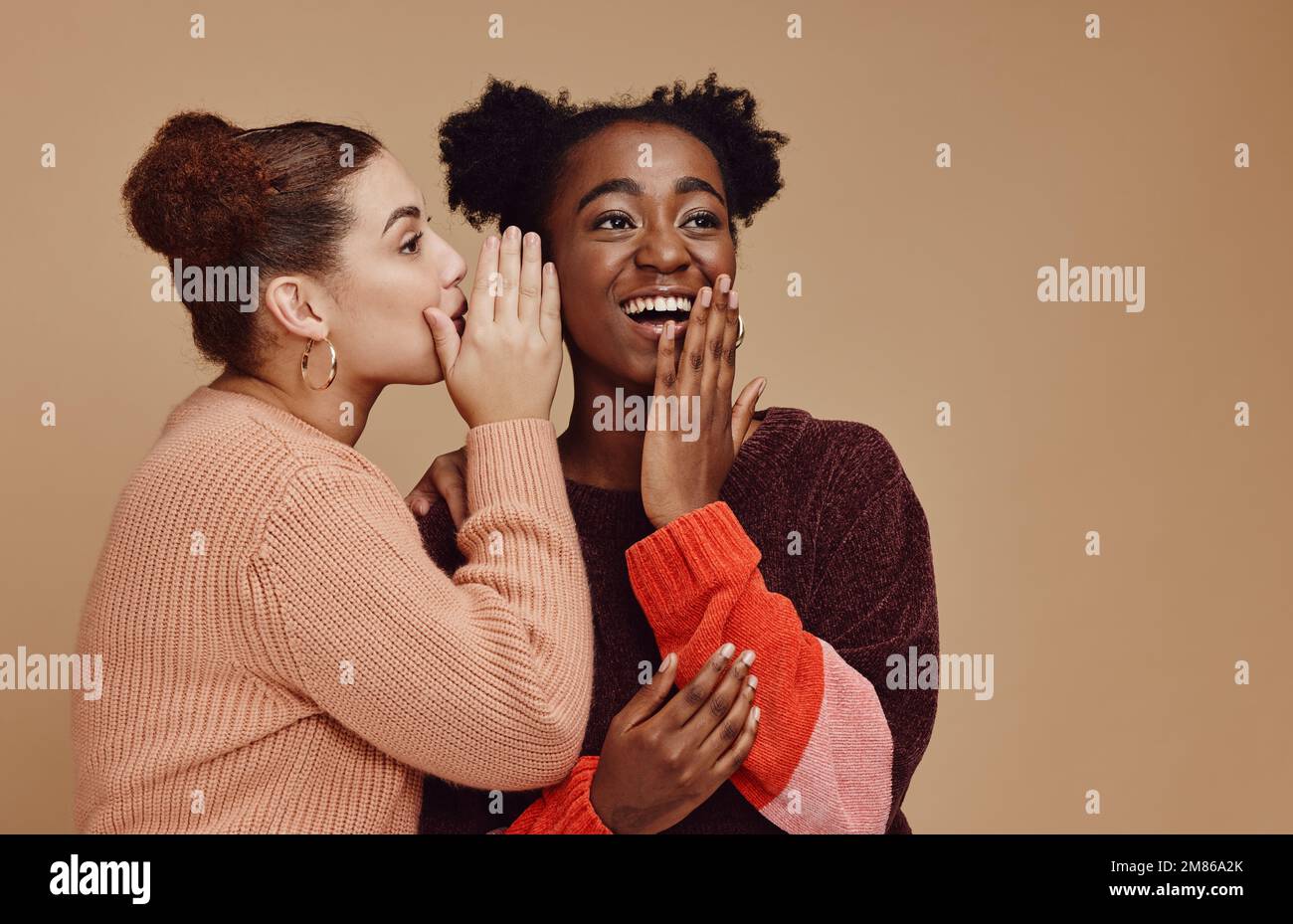Friends, gossip and black woman laughing at secret on studio background and product placement ...