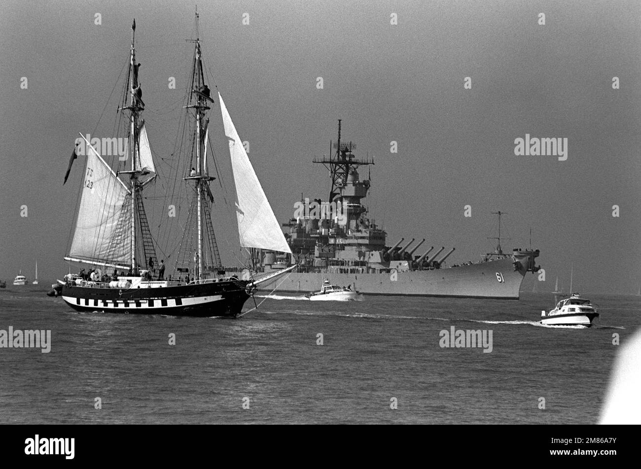 The battleship USS IOWA (BB-61) is welcomed by small boats and sailing ...