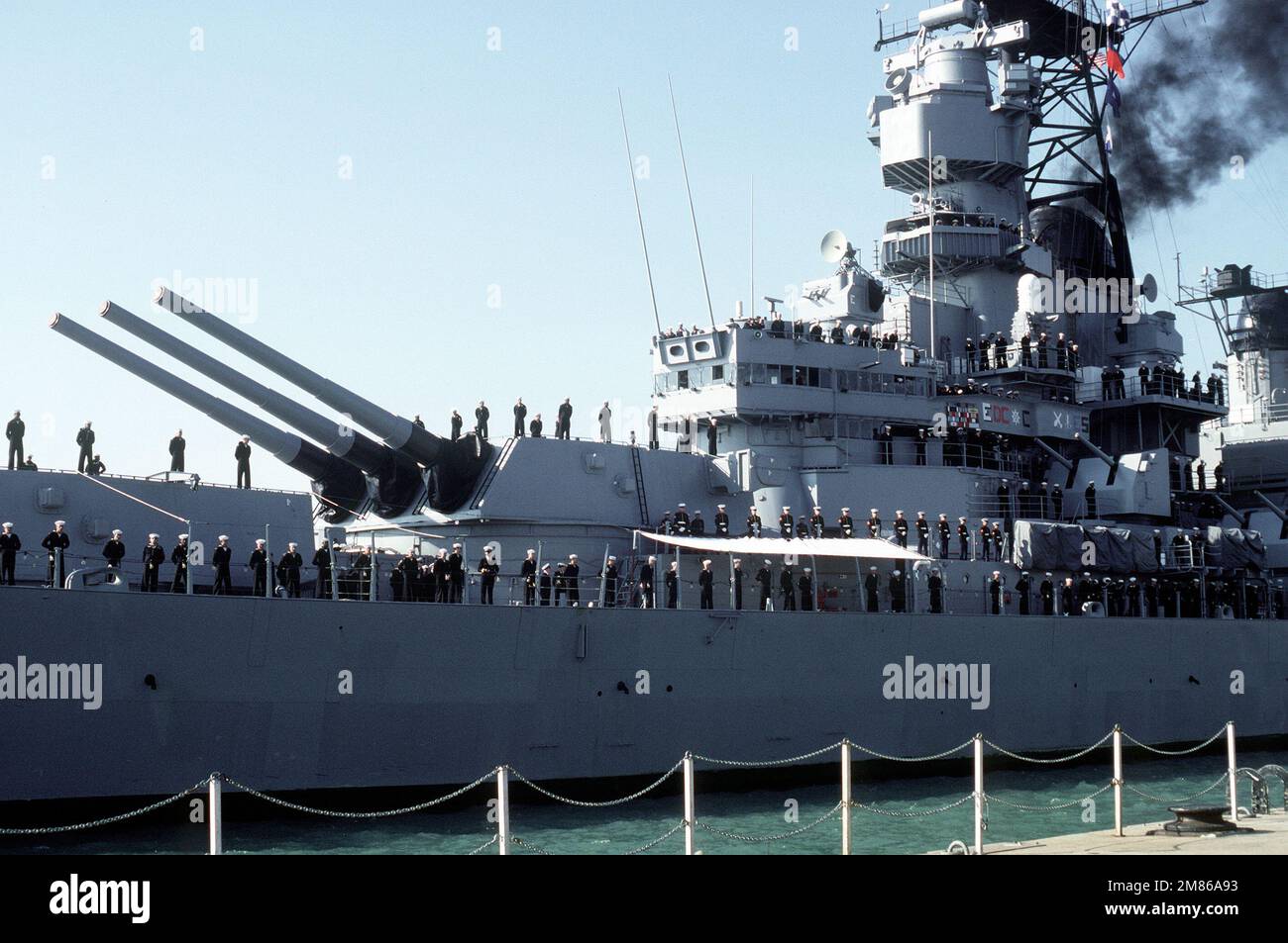 Crew members man the rail aboard the battleship USS IOWA (BB-61) as it ...
