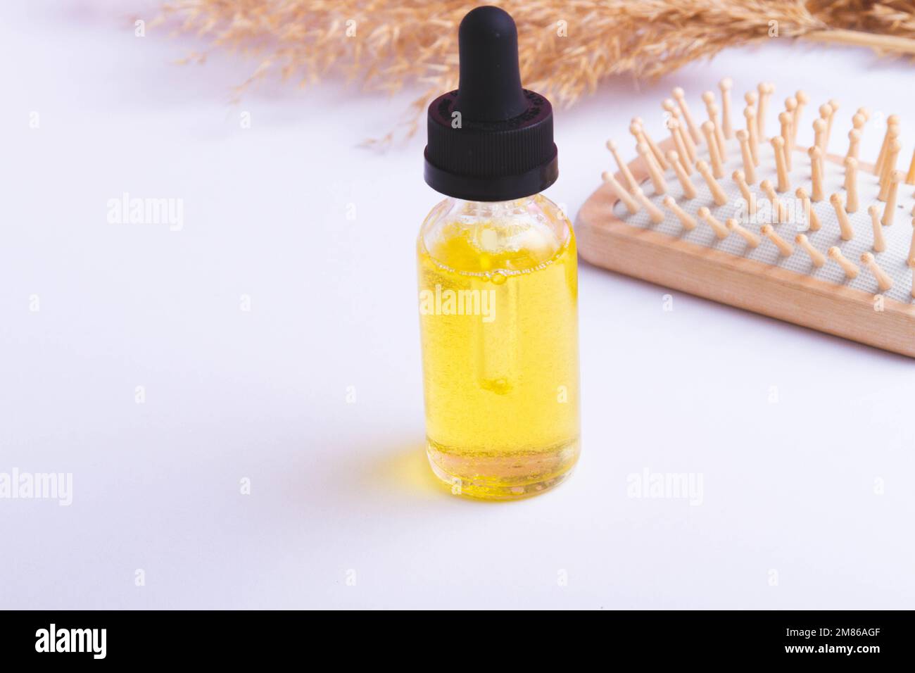 Oil for hair growth. Therapeutic oil to activate hair growth. Comb on ...