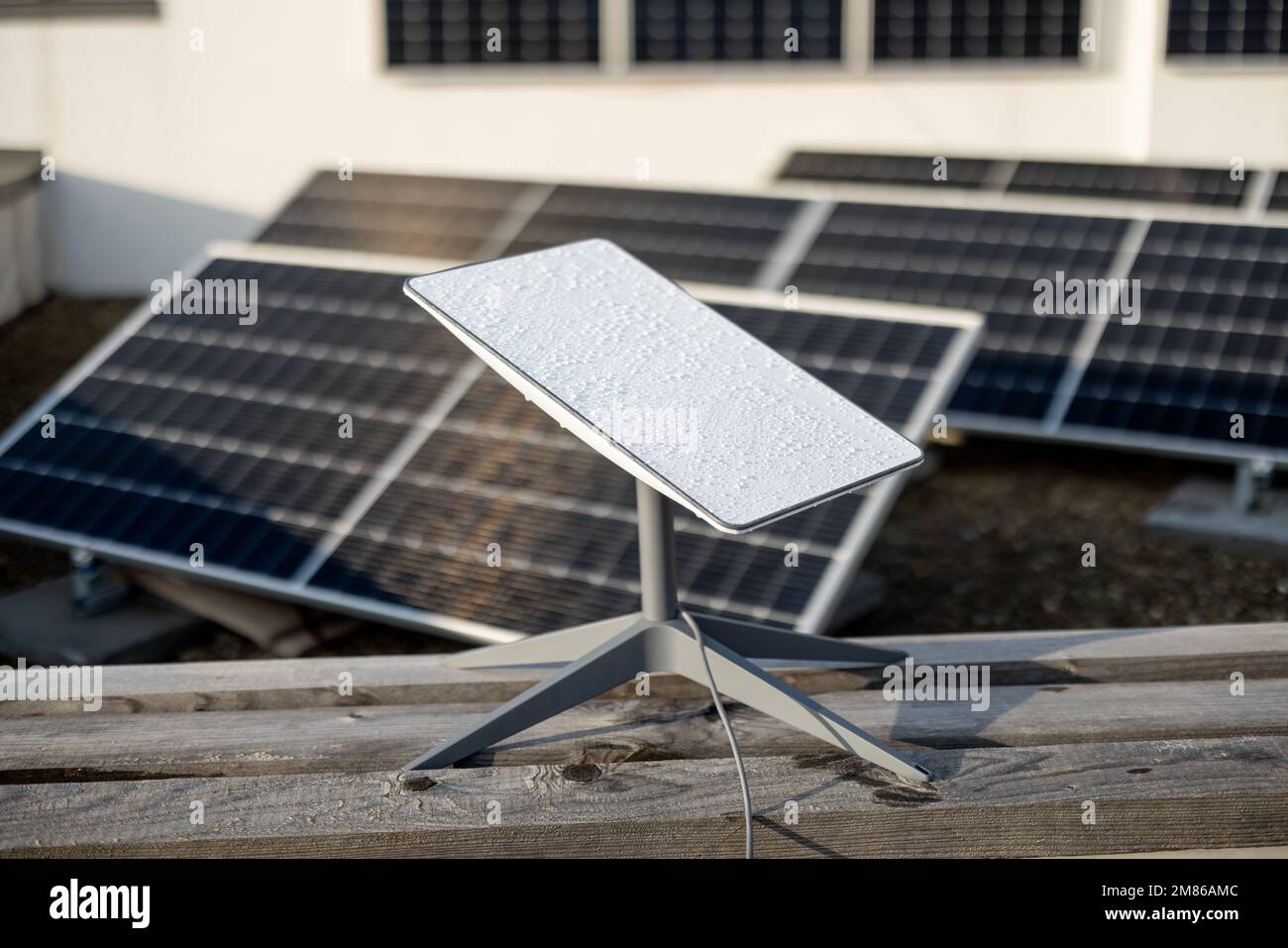 Starlink satellite dish on roof of residential building Stock Photo - Alamy