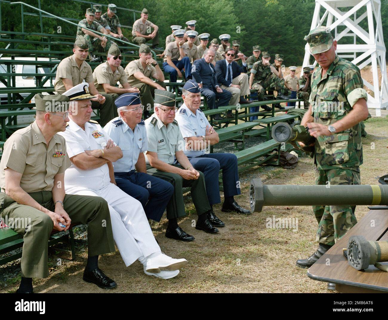 A Marine officer explains an AT-4 light anti-armor weapon to, from left ...