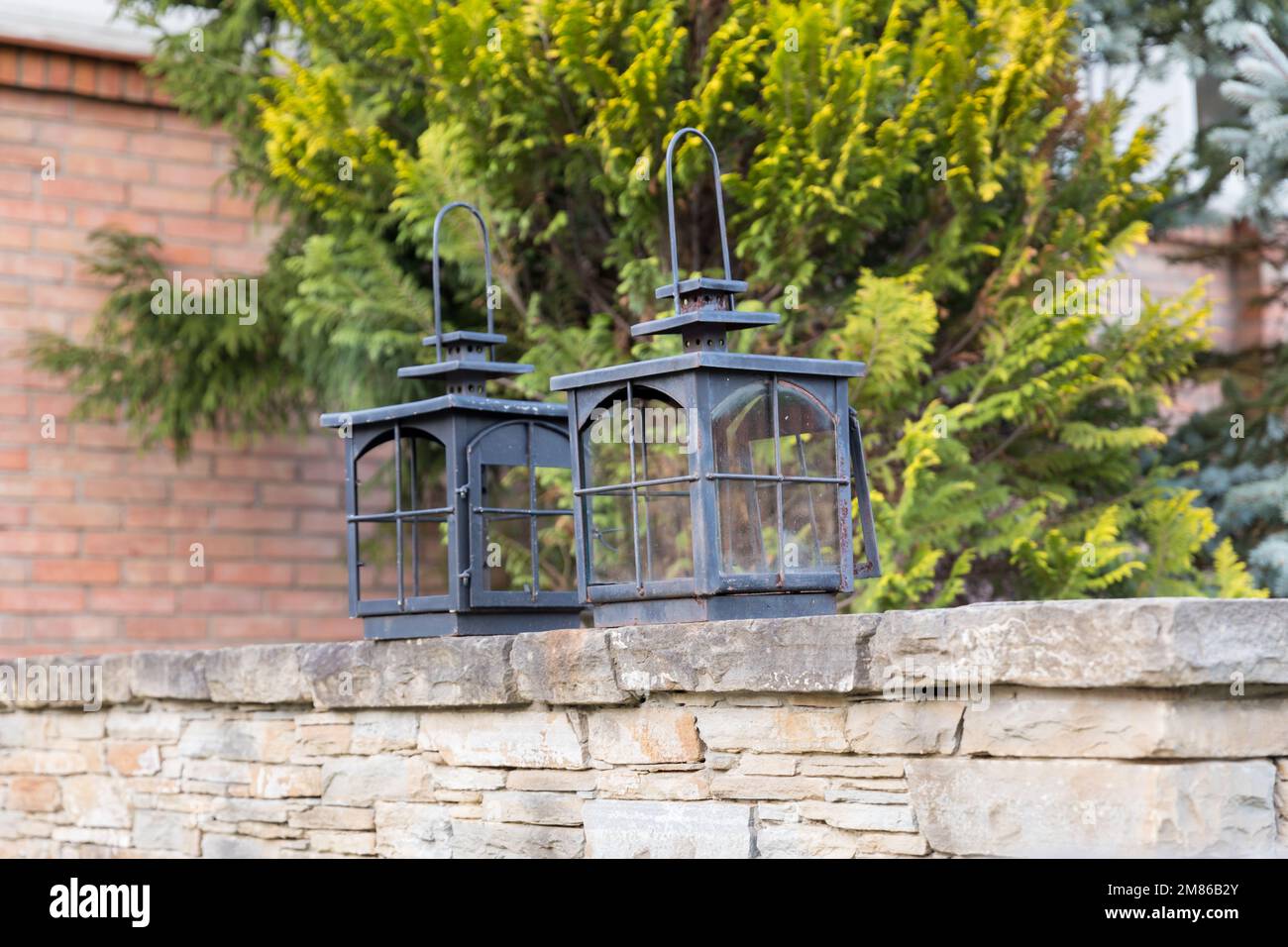 Metal lanterns set on a plinth, decoration in the garden Stock Photo ...