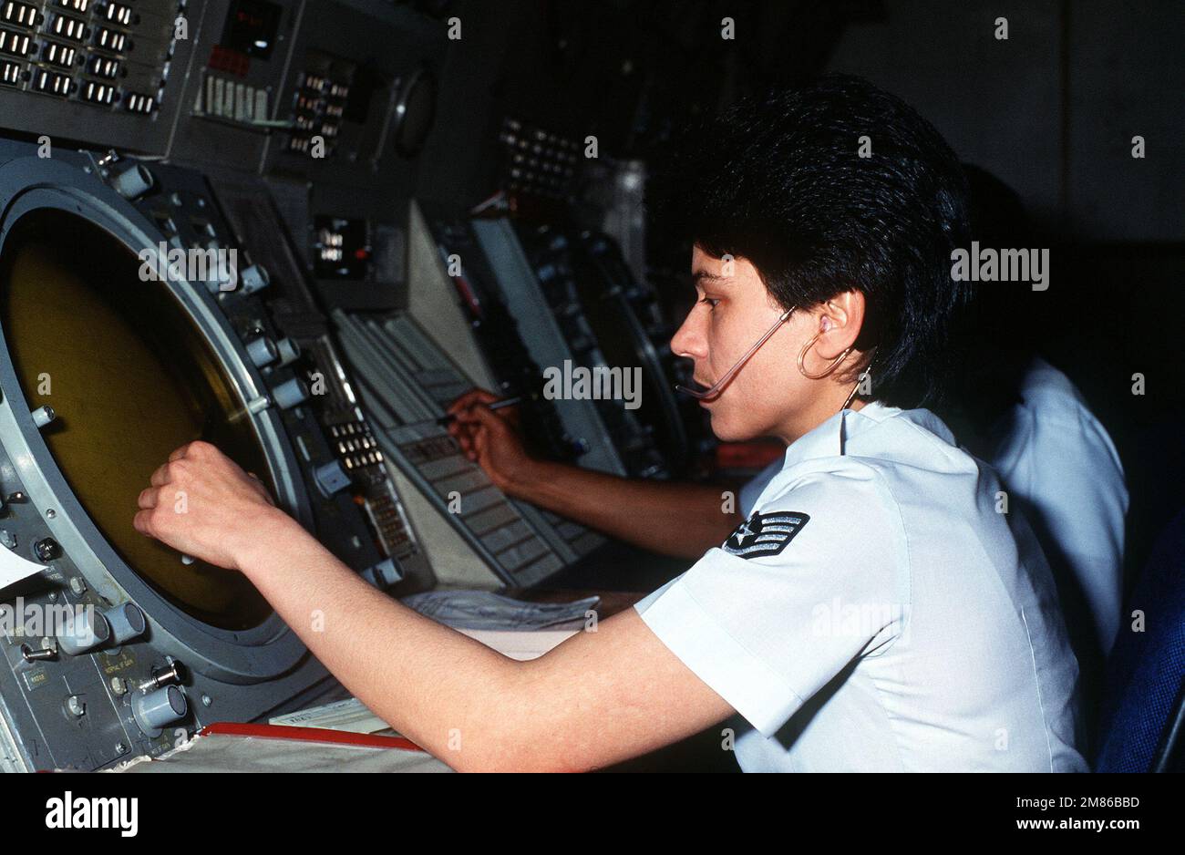 An air traffic controller tracks aircraft on a radar screen. Base ...