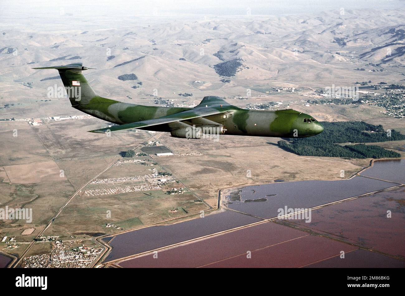 Air to air side view of a 60th Military Airlift Wing's C-141 Starlifter ...