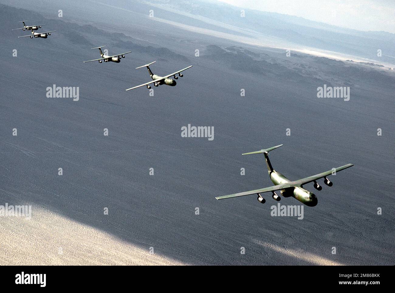 Air to air front view of a flight of five C-141 Starlifters, assigned ...