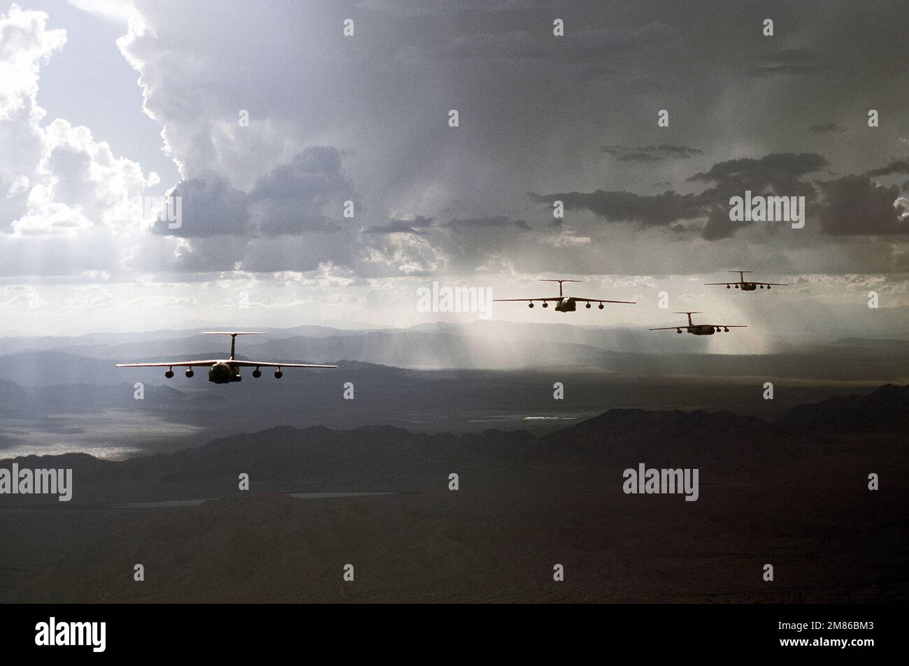 Air to air front view of a flight of four C-141 Starlifters, assigned ...