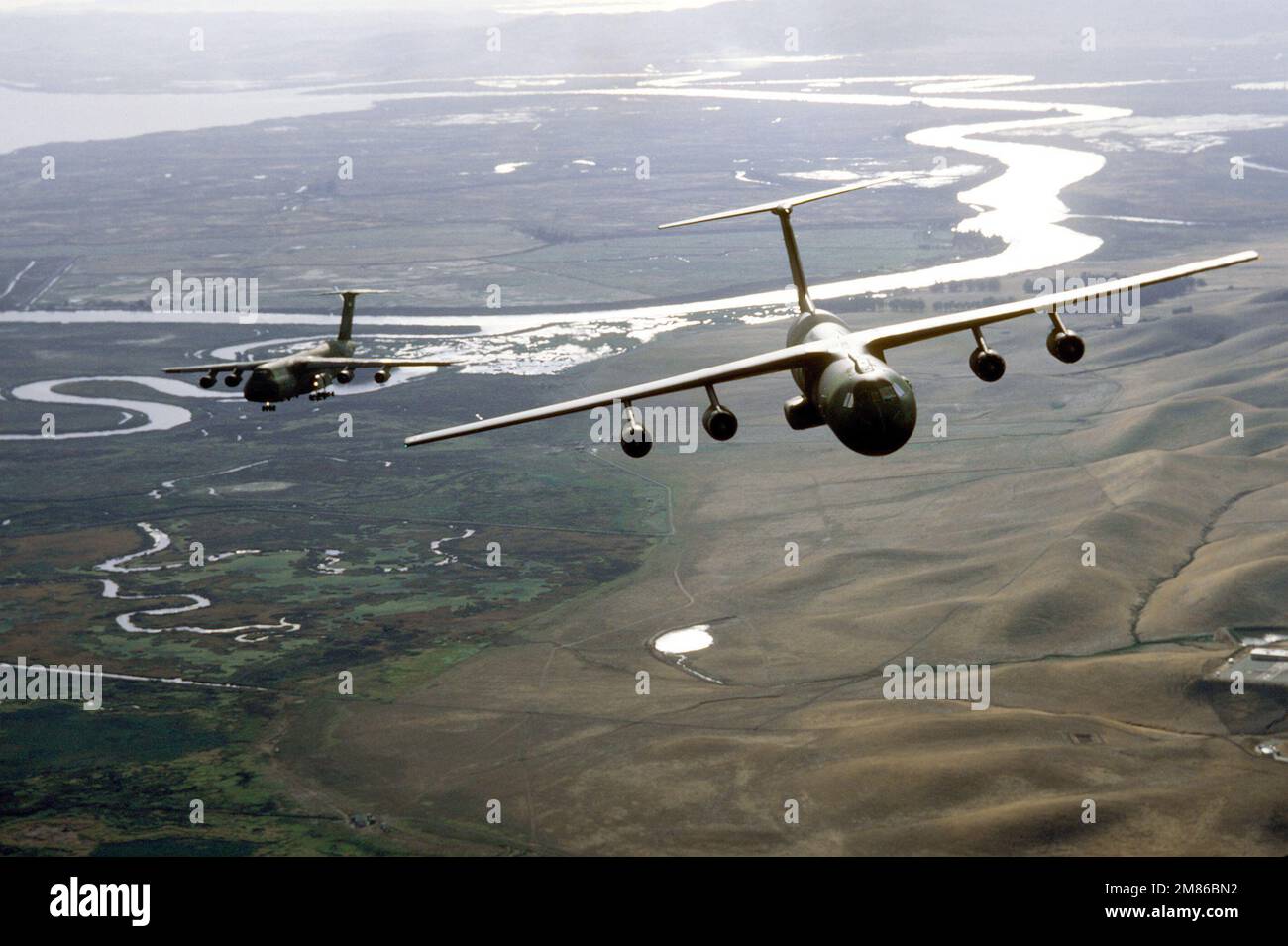 Air to air front view of a C-141 Starlifter and a C-5 Galaxy, assigned ...