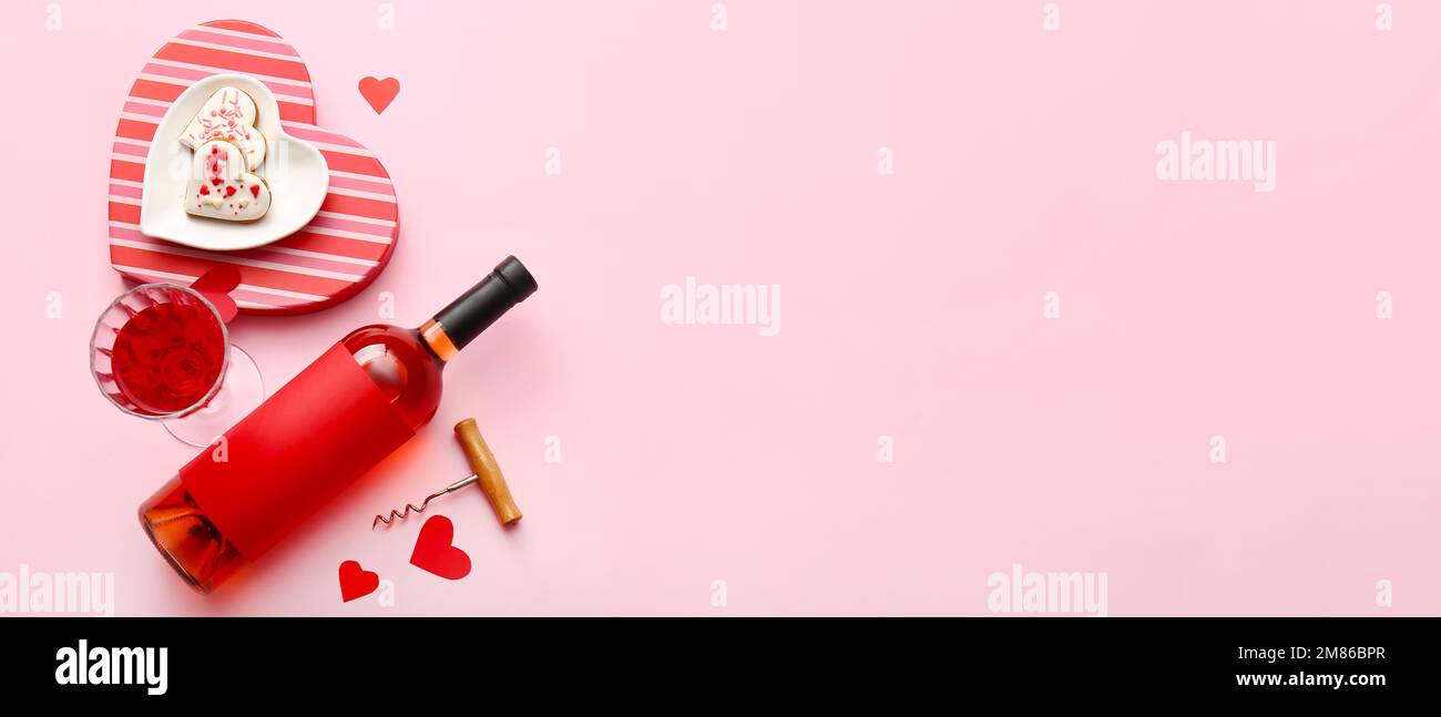 Bottle and glass of red wine, heart shaped cookies and corkscrew on ...