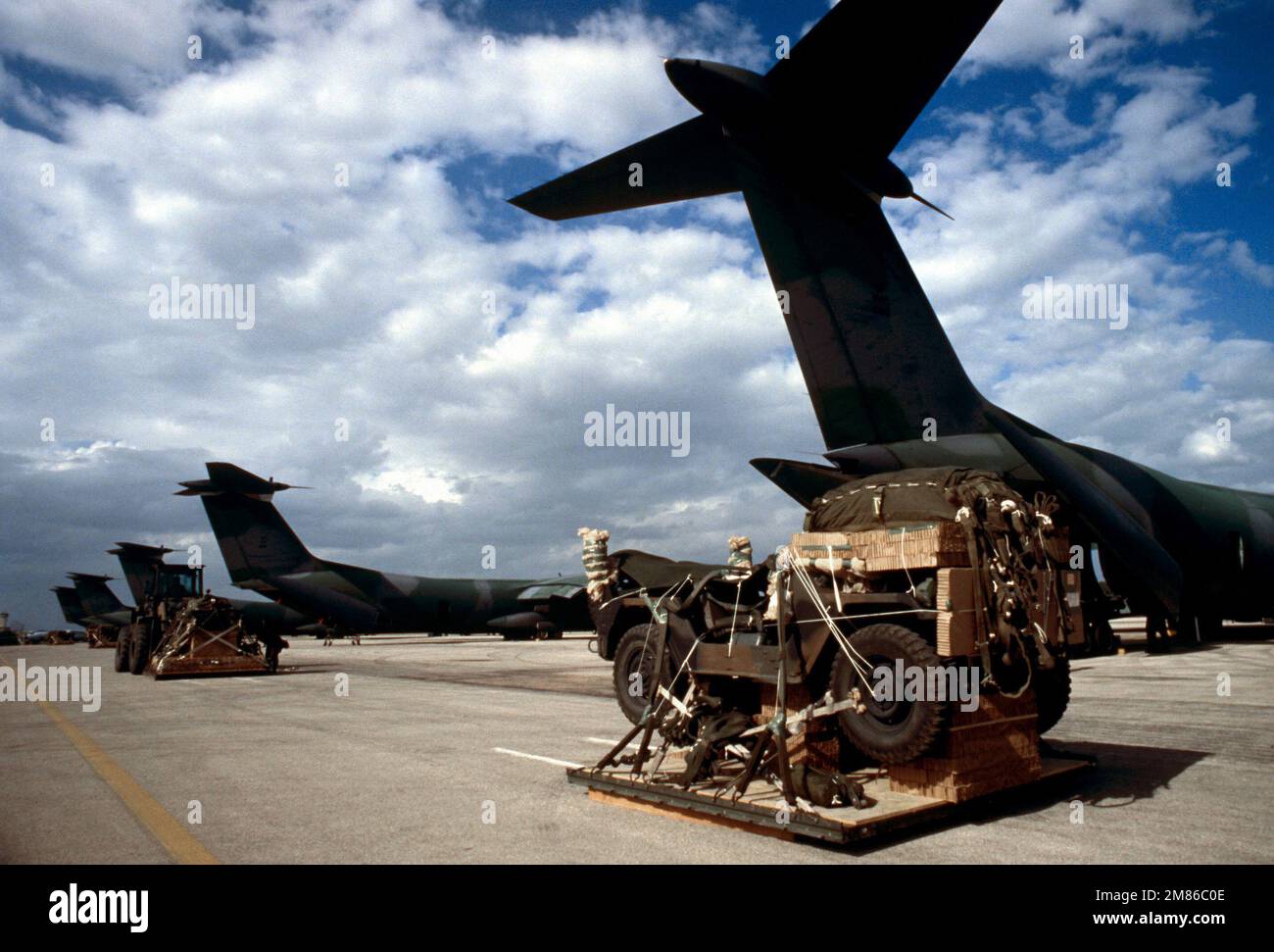 Palletized U.S. Army jeeps await loading onto waiting Air Mobility ...