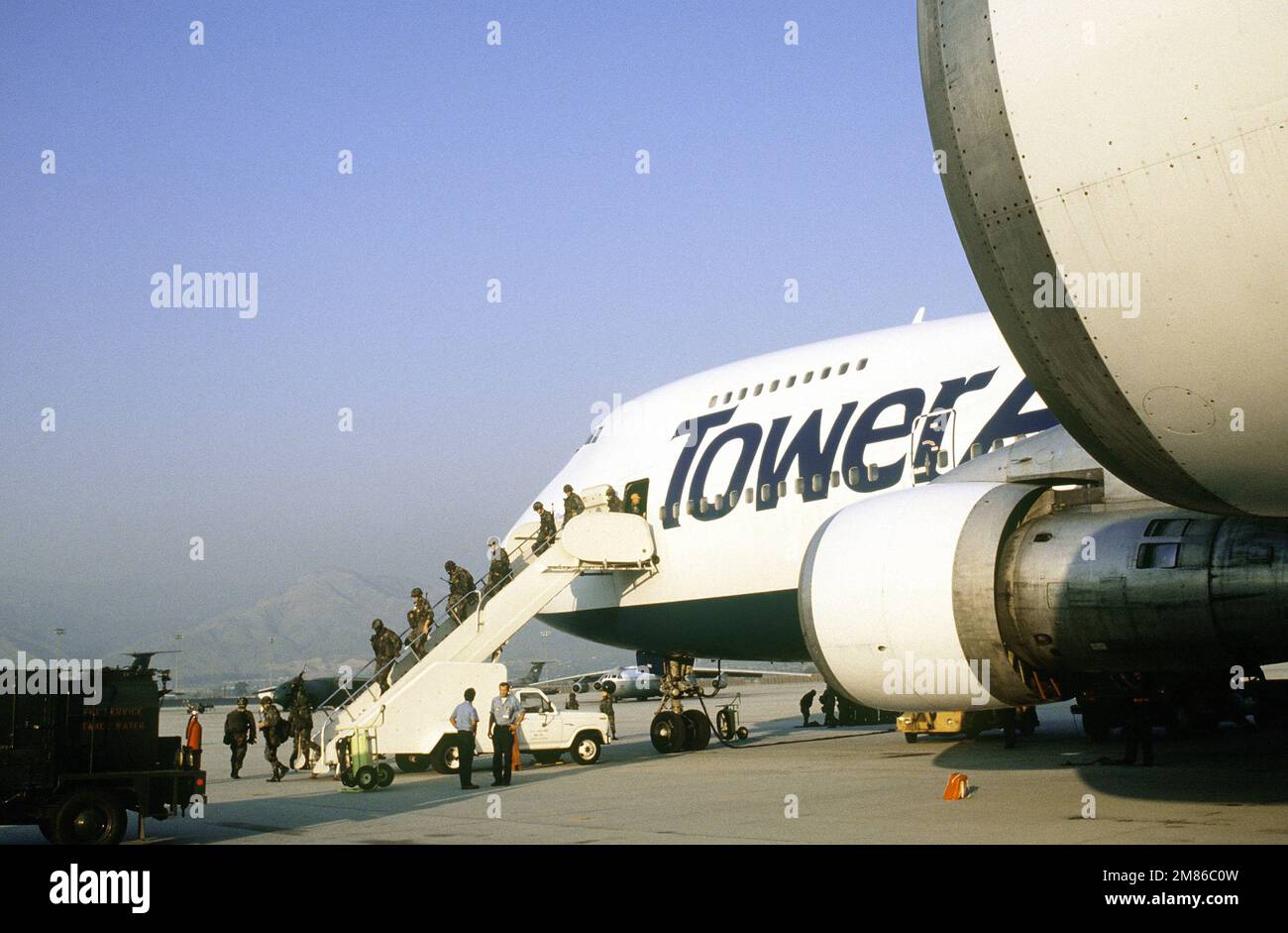 U.S. Army personnel offload from a Military Airlift Command contracted ...