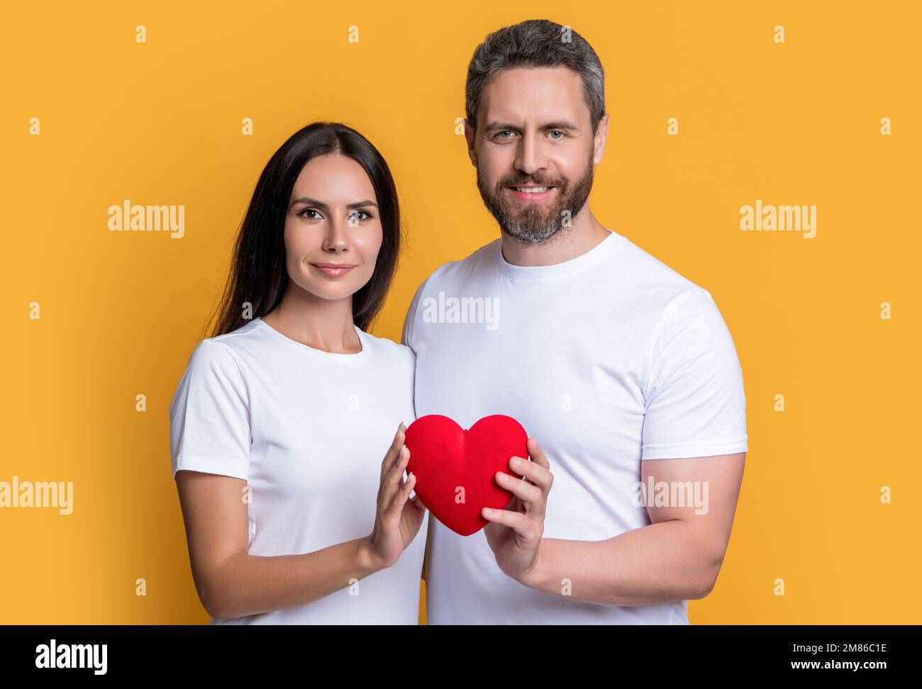 couple in love with valentine heart isolated on yellow. couple with ...