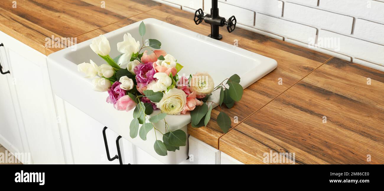 Sink with beautiful bouquet of flowers in modern kitchen Stock Photo ...