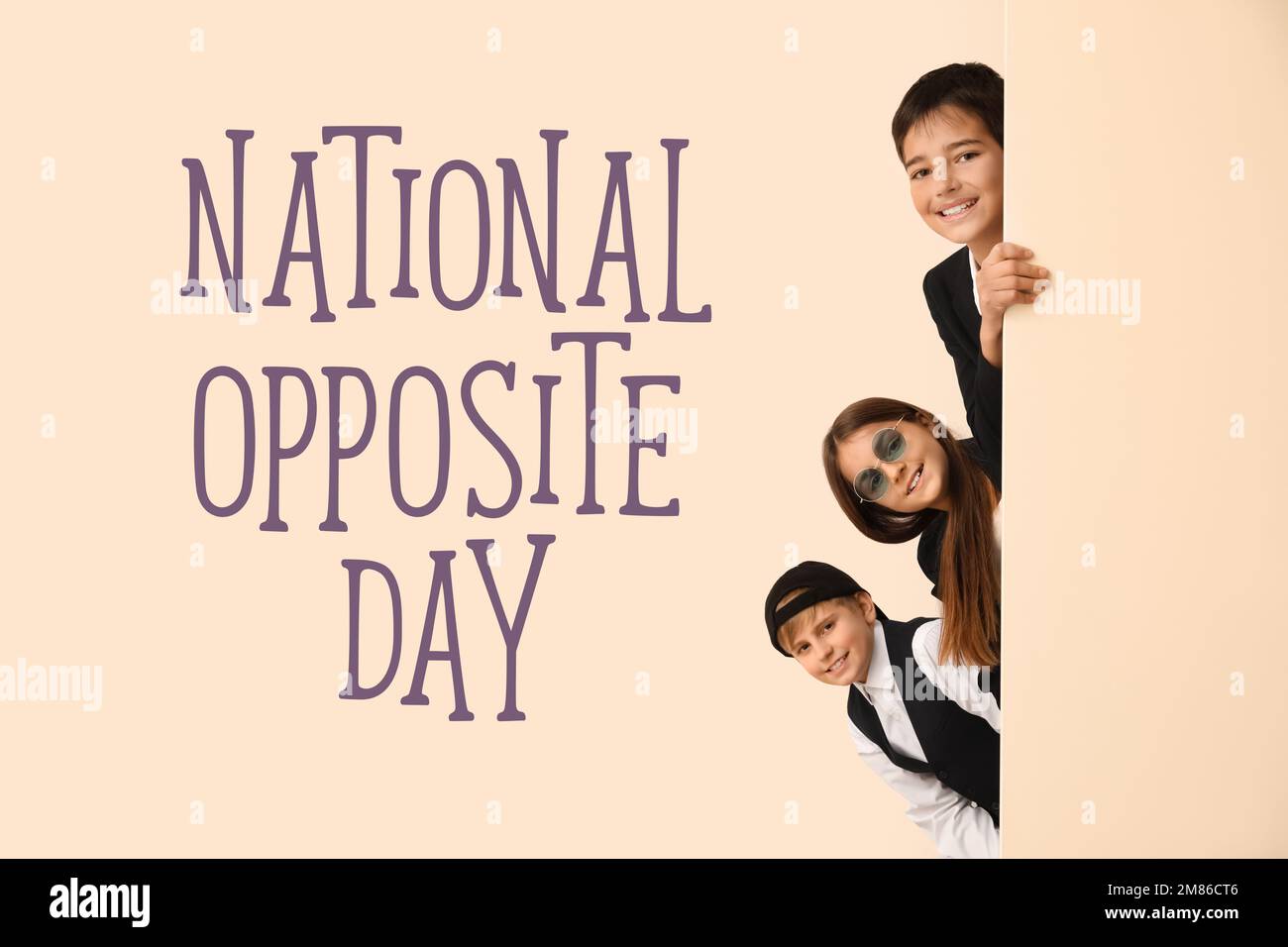 Little friends and big poster with text NATIONAL OPPOSITE DAY on light ...