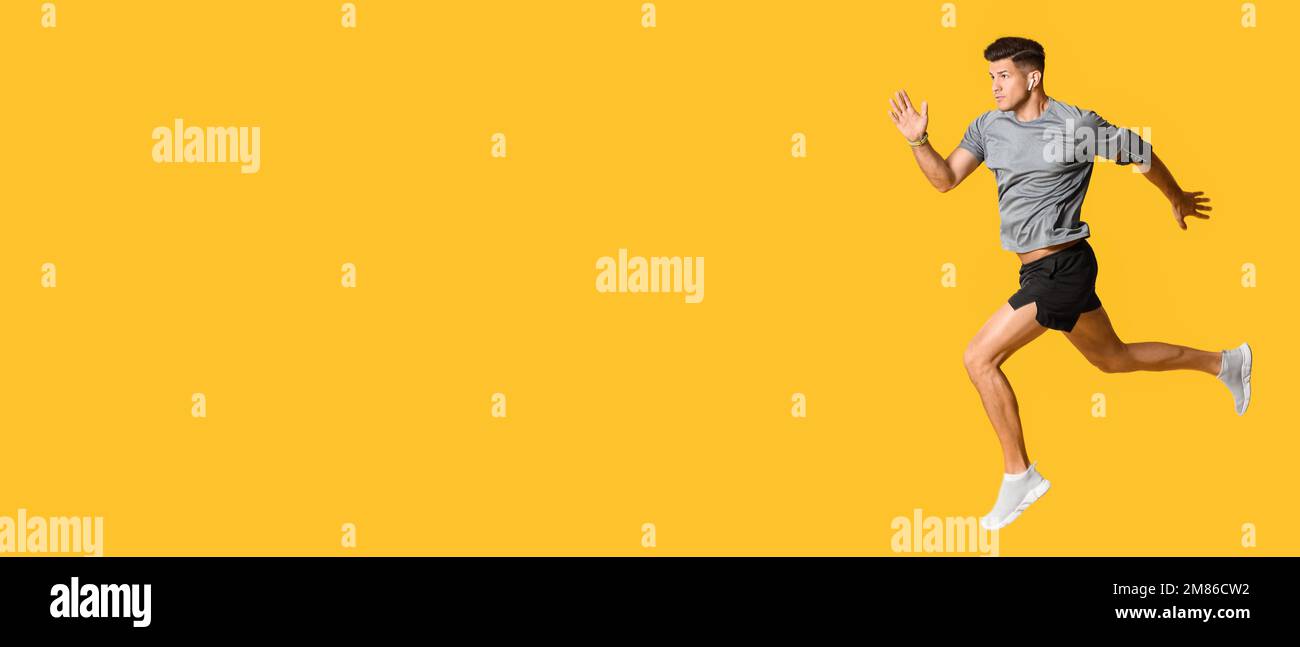Sporty running man on yellow background with space for text Stock Photo ...
