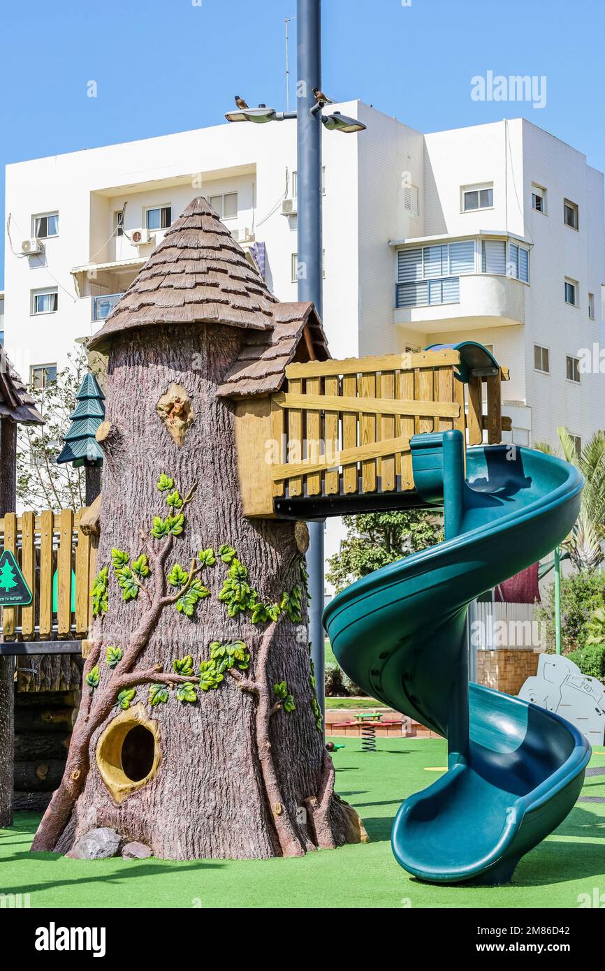 View of children's complex with slide on playground Stock Photo - Alamy