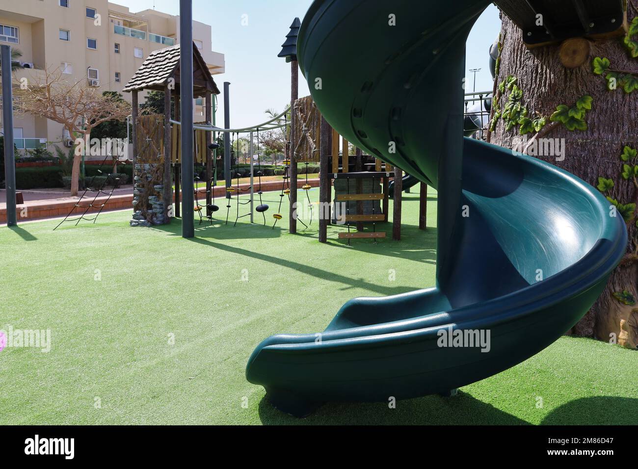 View of children's complex with slide on playground Stock Photo - Alamy