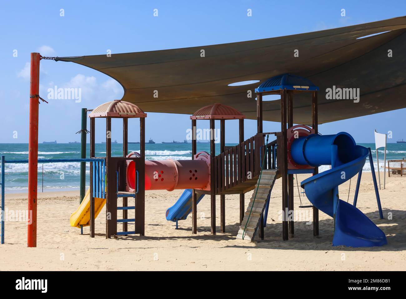 Children's playground with slide on beach Stock Photo - Alamy