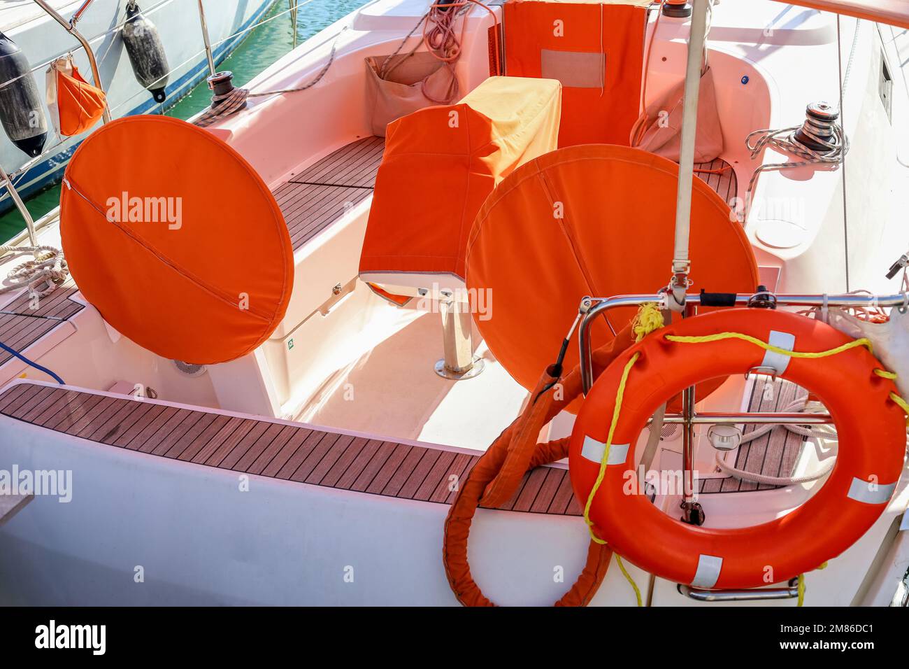 Modern yacht with ring buoy at pier Stock Photo - Alamy