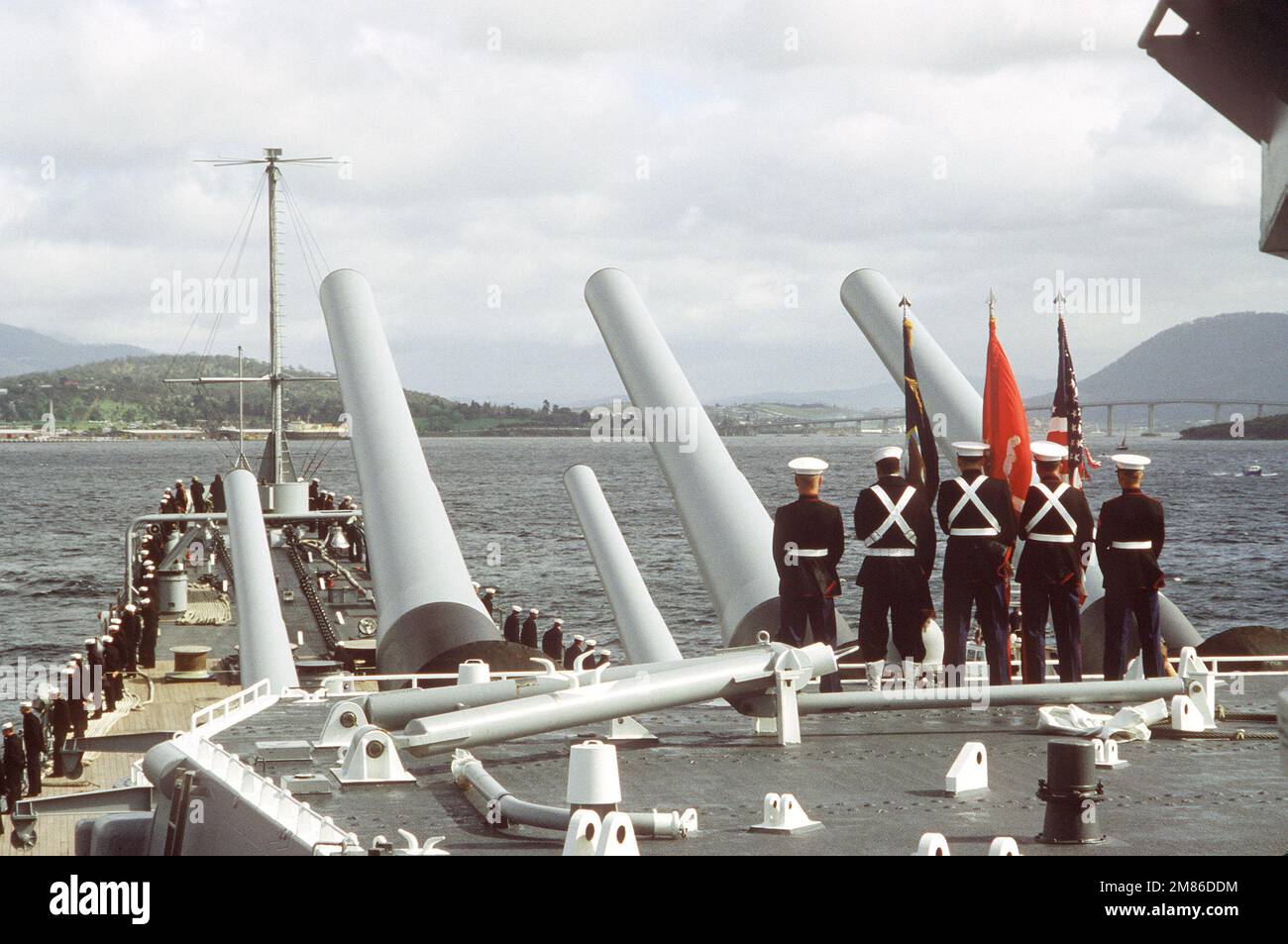 A color guard stands on the No. 1 Mark 7 50-caliber/16-inch gun turret ...