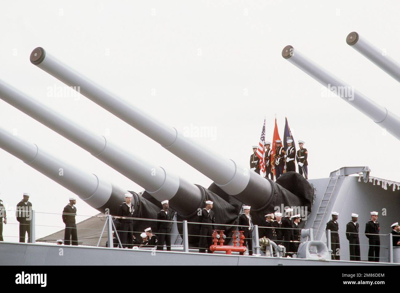 A color guard stands on the No. 1 Mark 7 50-caliber/16-inch gun turret ...