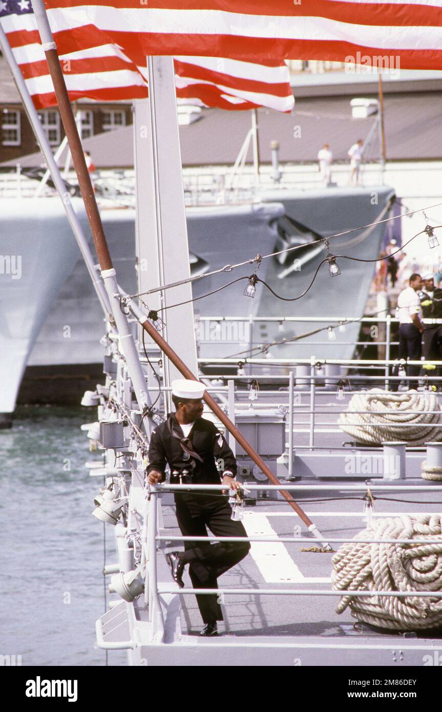 A crewman stands watch on the fantail of a U.S. Navy ship during ...