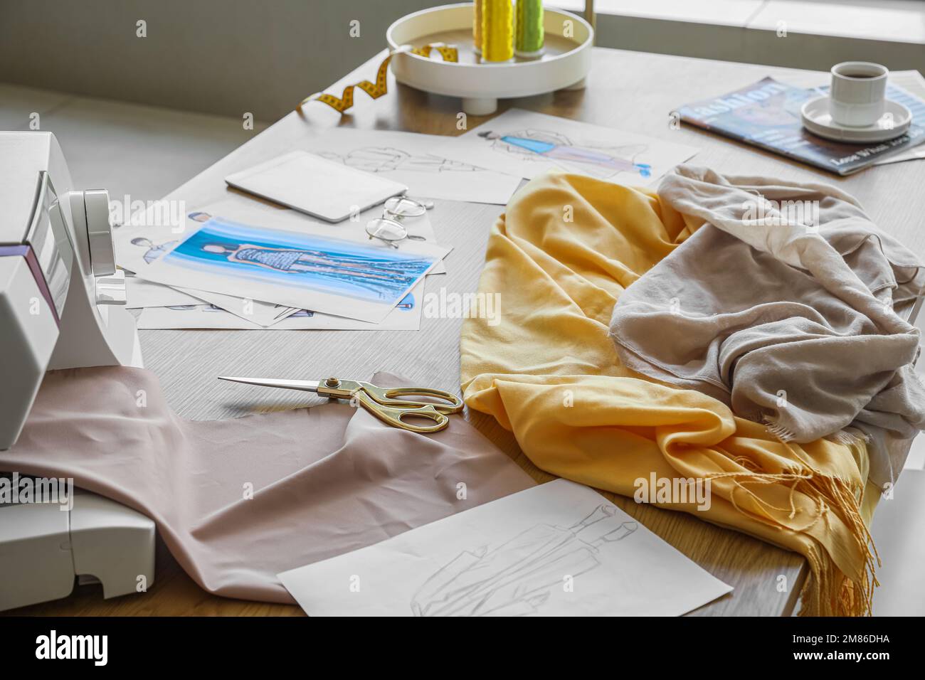Tailor's workplace with fabric and sketches in atelier, closeup Stock ...