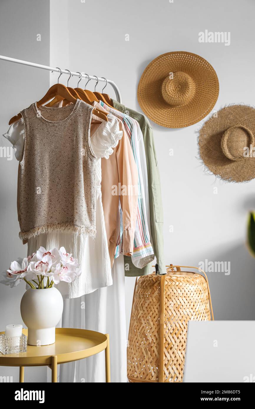 Rack with clothes in modern atelier Stock Photo - Alamy