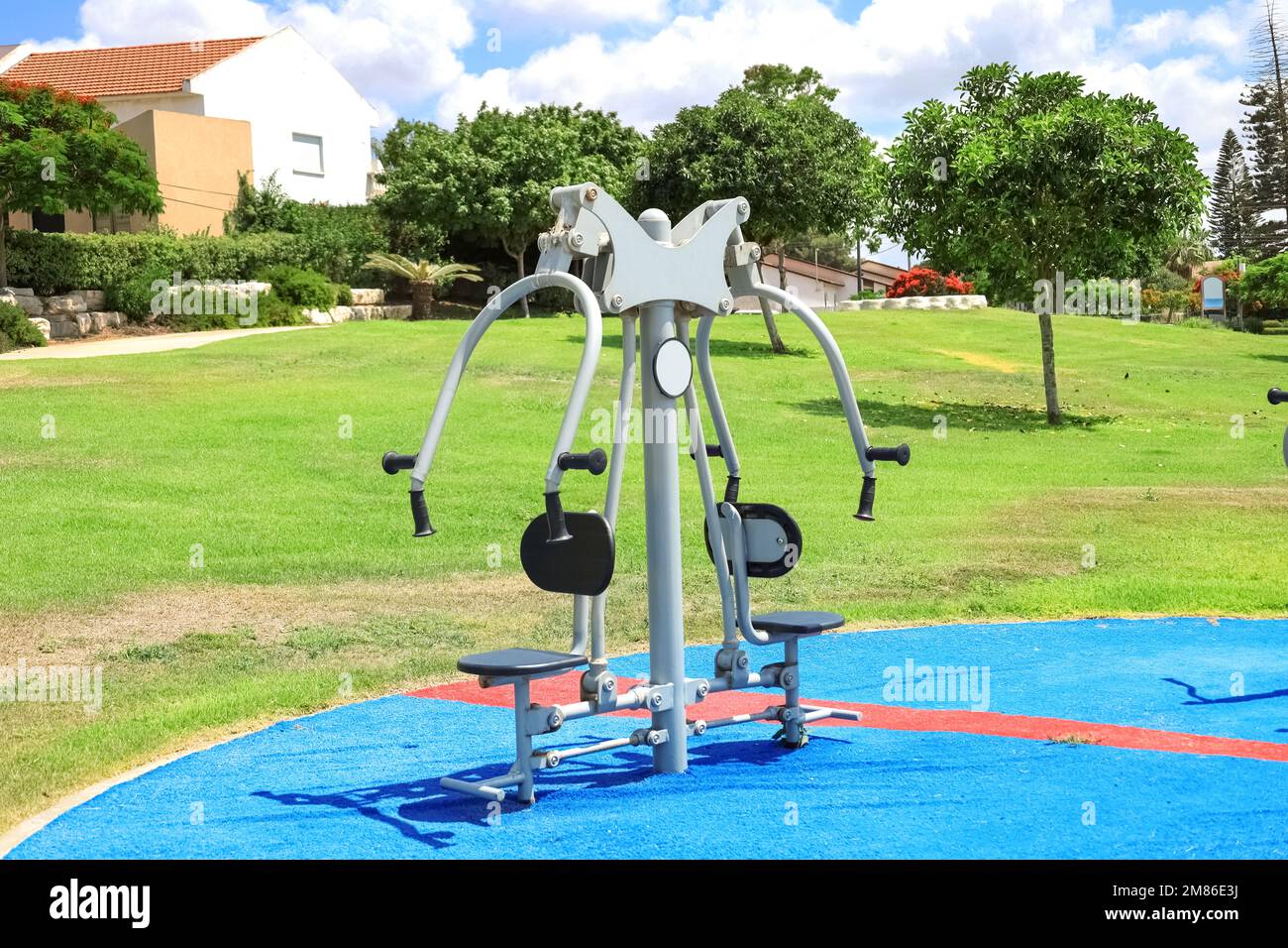 Modern exercise equipment on sport ground in city Stock Photo - Alamy
