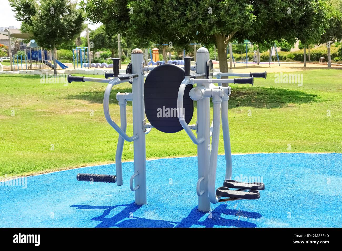 Modern exercise equipment on sport ground in city Stock Photo - Alamy