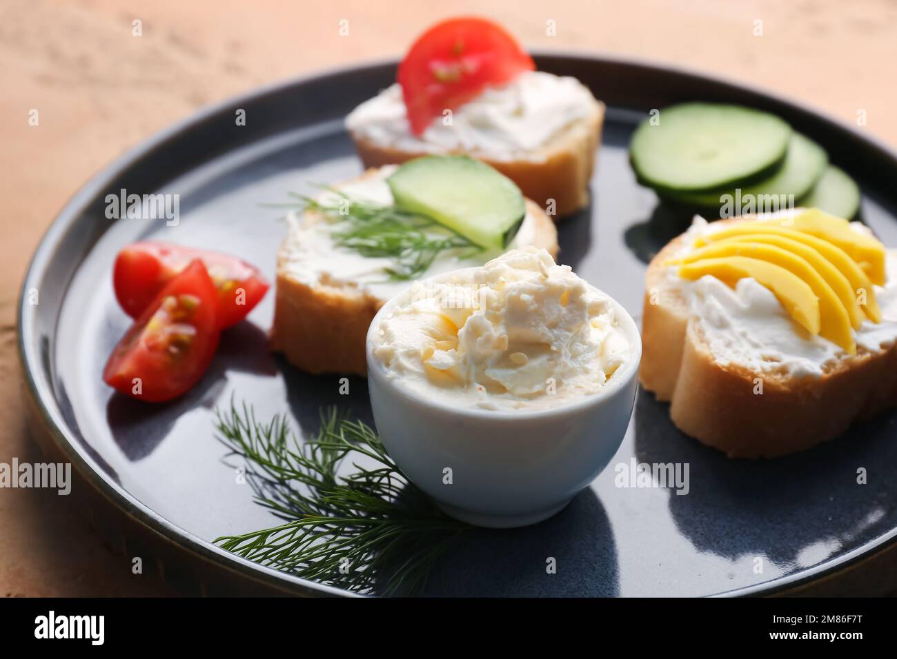 Plate of tasty sandwiches with cream cheese on color background ...