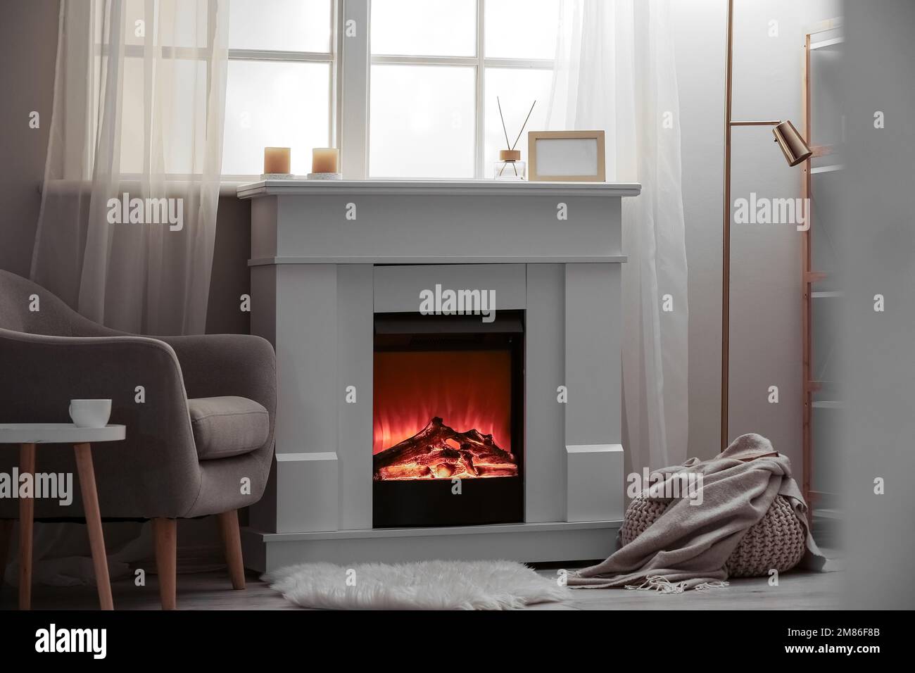 Interior of modern living room with electric fireplace and window Stock ...