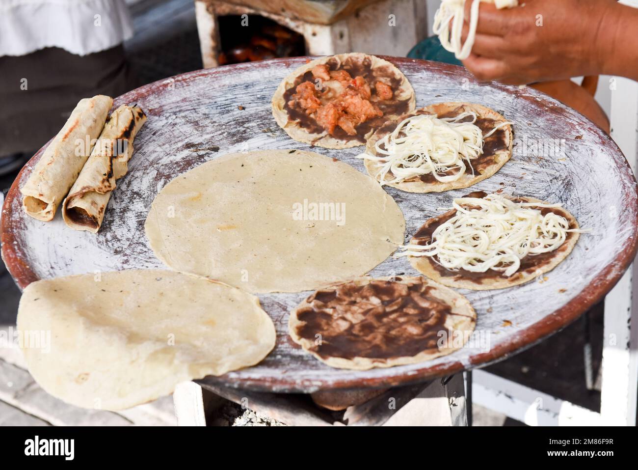 Tlayudas (big roasted tortillas) at a street food stall in Oaxaca city ...