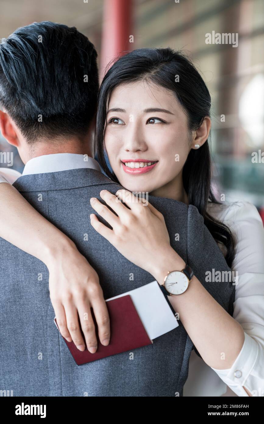 Young lovers together hug at the airport Stock Photo - Alamy
