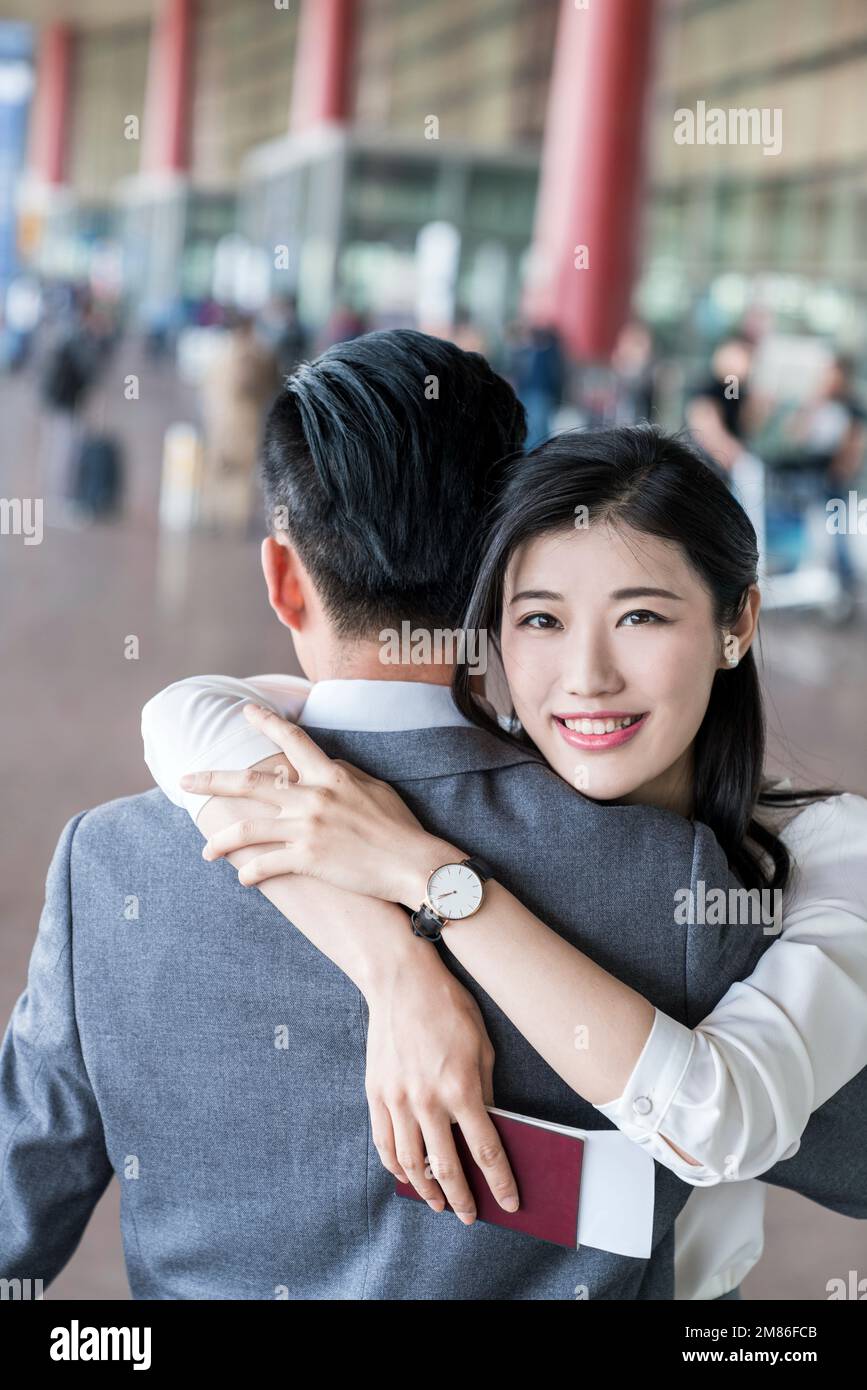 Young lovers together hug at the airport Stock Photo - Alamy