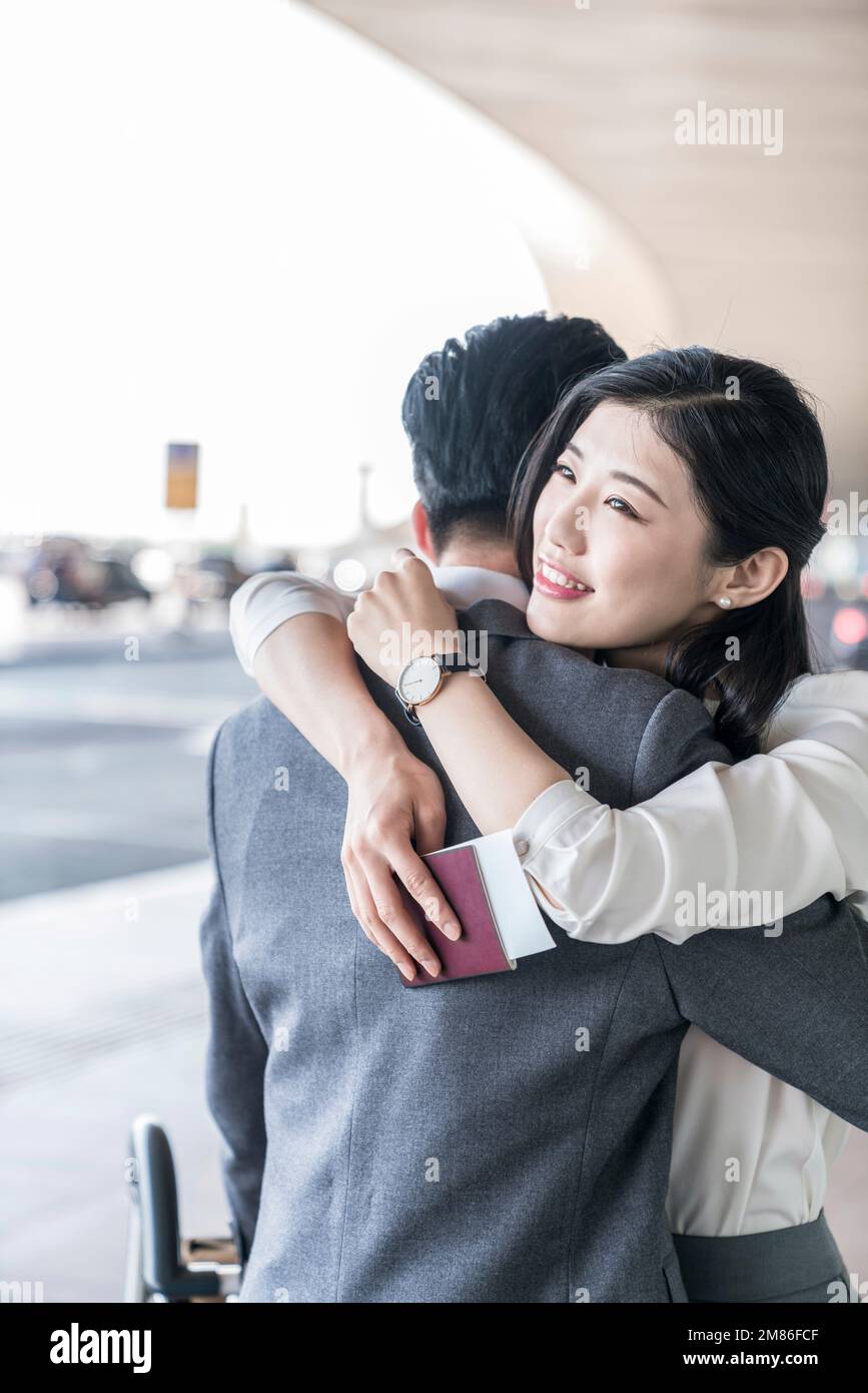 Two friends hug airport hi-res stock photography and images - Alamy