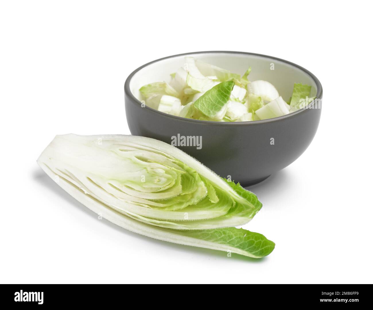 Bowl of cut endive on white background Stock Photo - Alamy