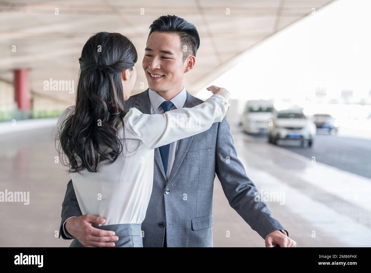 Two friends hug airport hi-res stock photography and images - Alamy