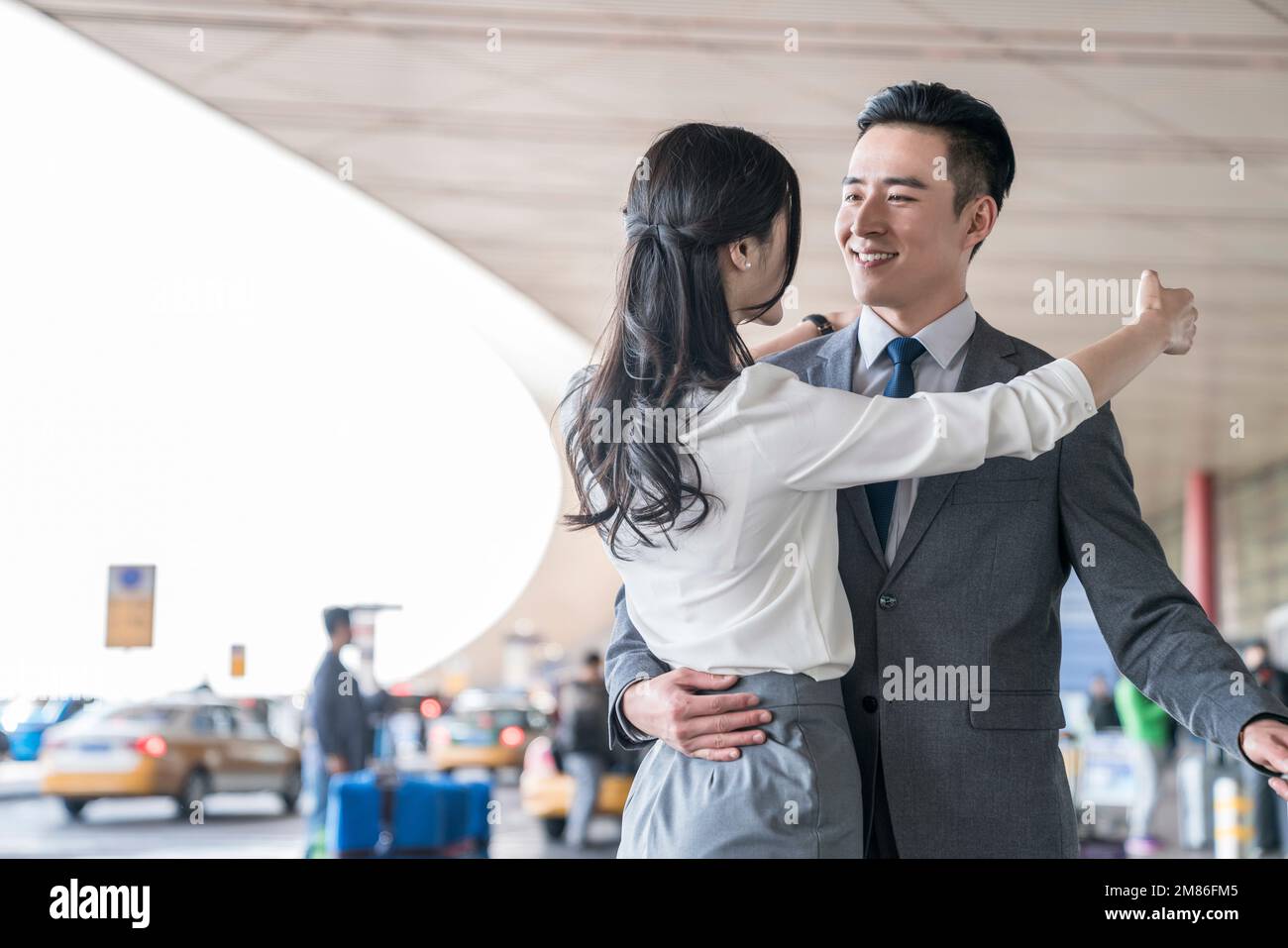 Two friends hug airport hi-res stock photography and images - Alamy