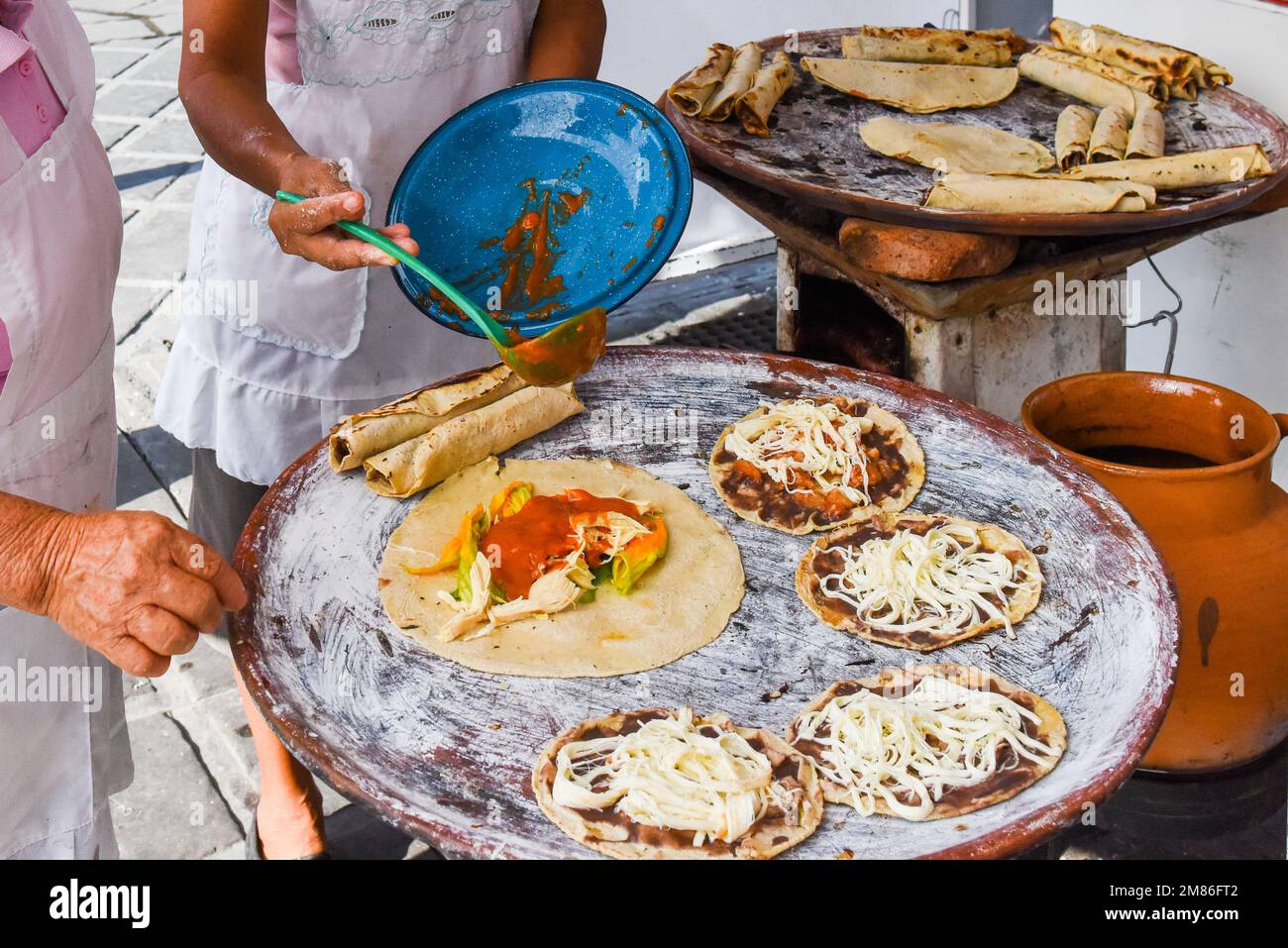 Tlayudas being prepared at a street food stall in Oaxaca city Mexico Stock Photo - Alamy