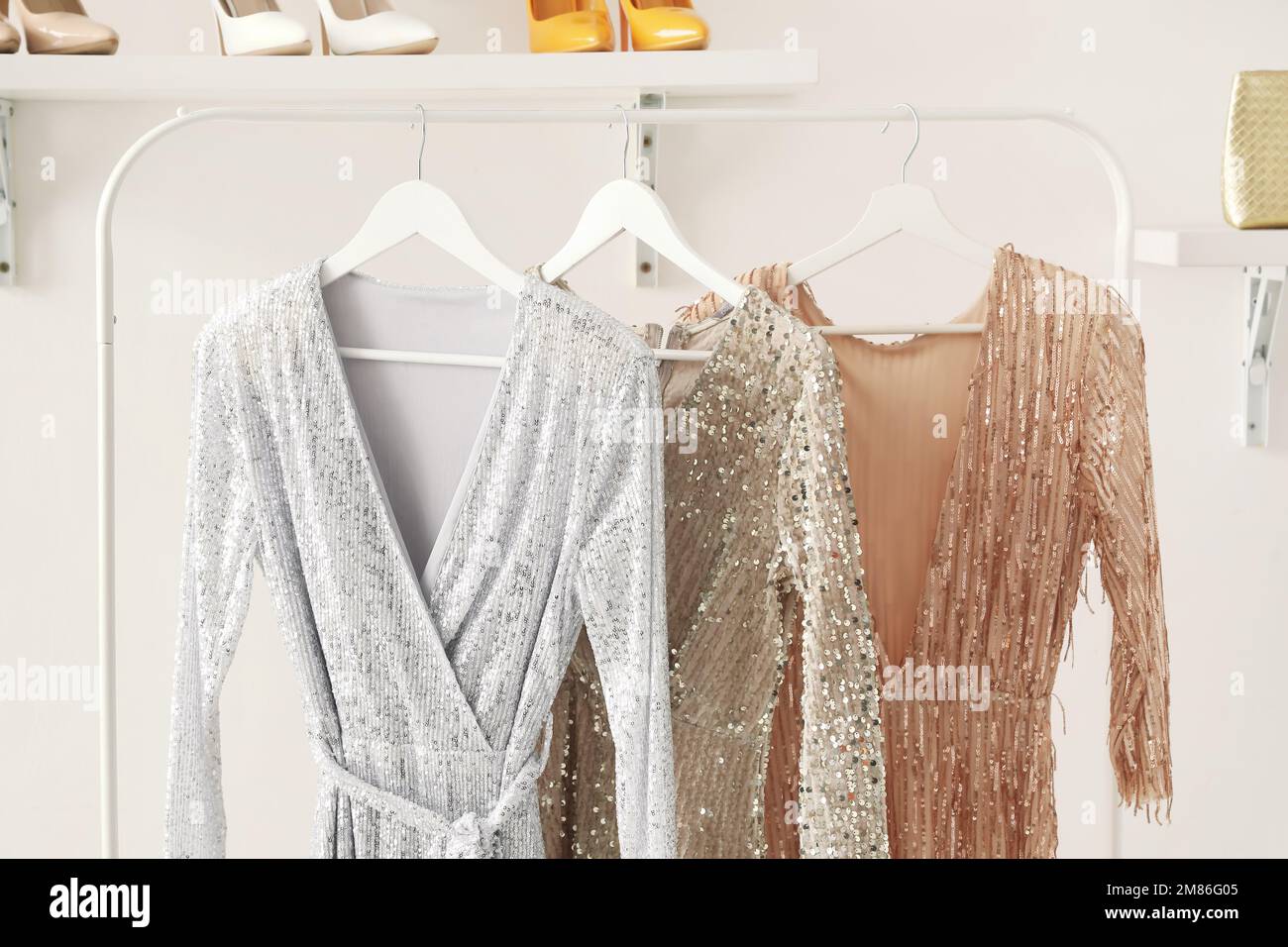 Rack with stylish female dresses in dressing room, closeup Stock Photo ...