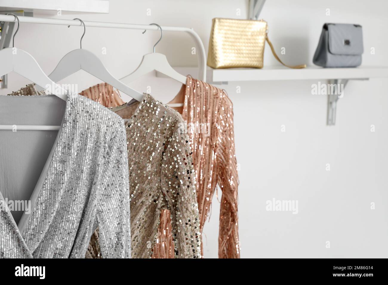 Rack with stylish female dresses in dressing room, closeup Stock Photo ...