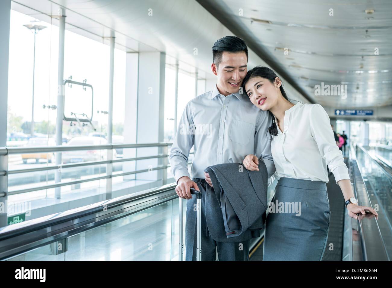 Young couples take elevator at the airport Stock Photo - Alamy