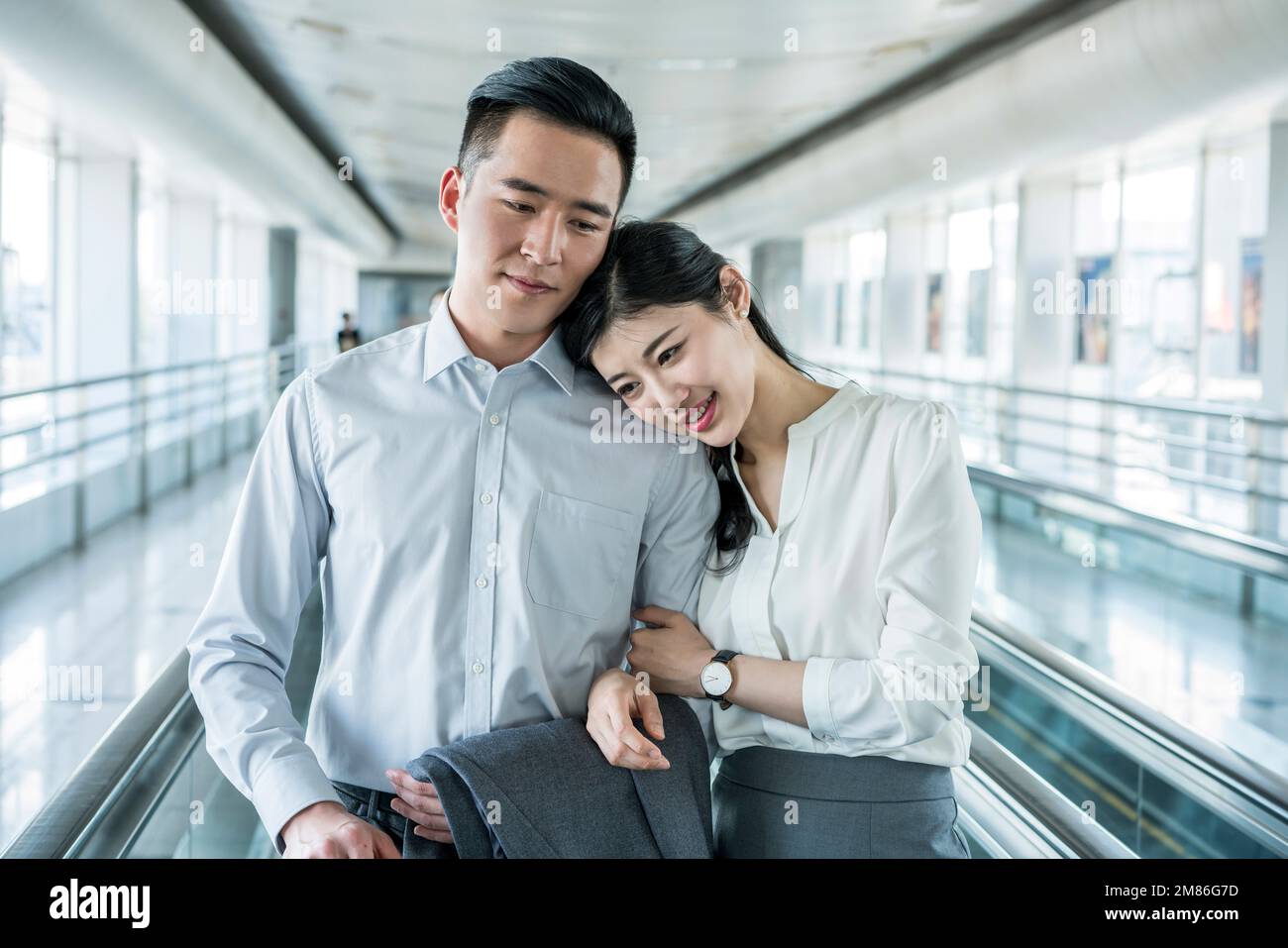 Young couples take elevator at the airport Stock Photo - Alamy