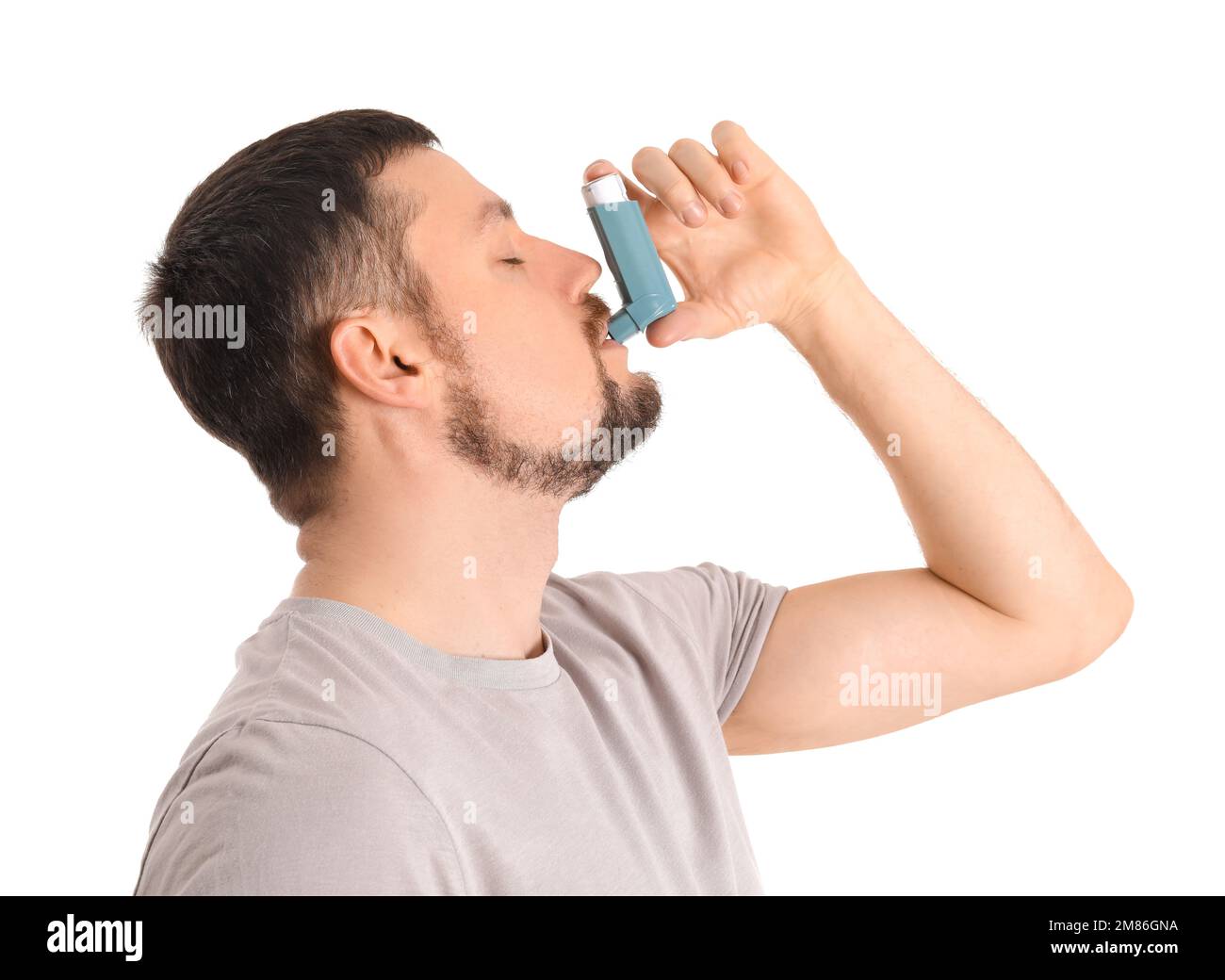 Sick man with inhaler on white background Stock Photo - Alamy
