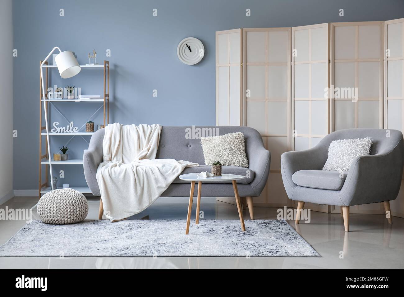 Interior of living room with sofa, armchair and folding screen Stock ...