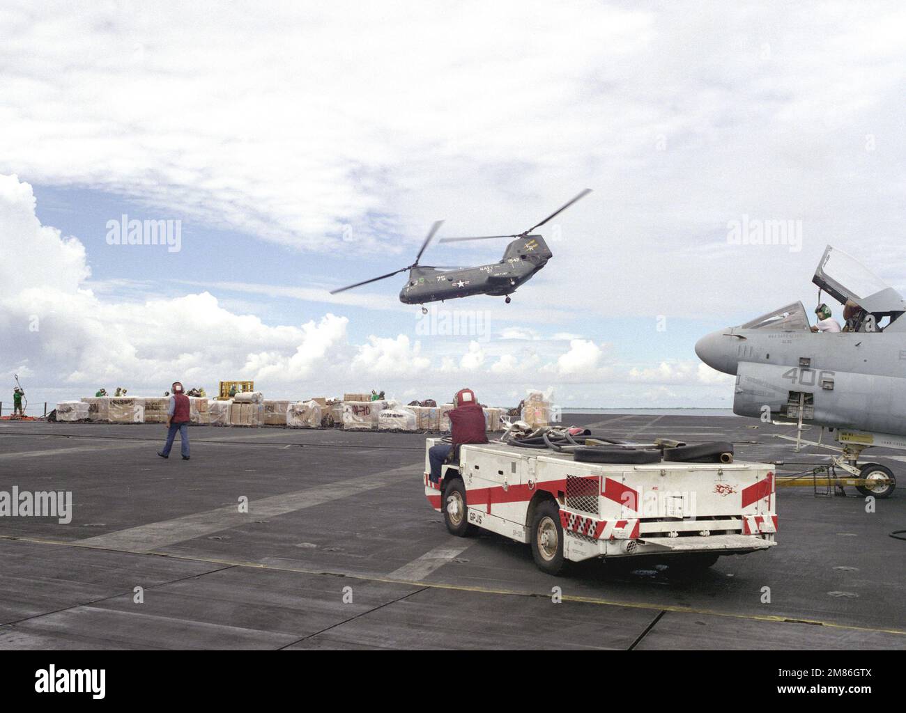 A flight deck crewman stands by in a crash vehicle as a Helicopter ...